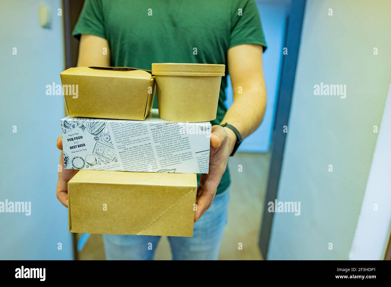 Man holding packed food in arms Stock Photo - Alamy