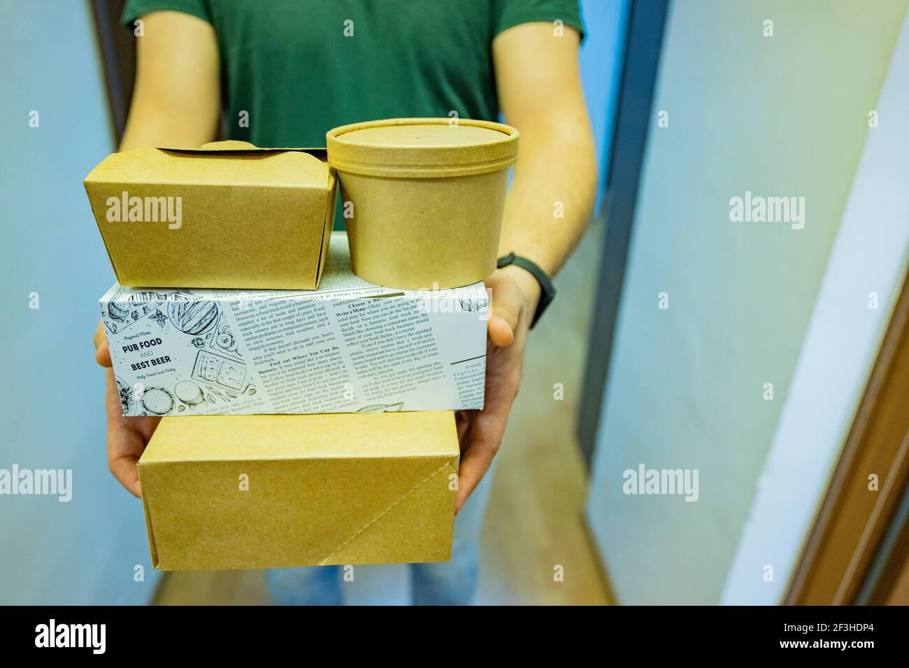 Man holding packed food in arms Stock Photo - Alamy