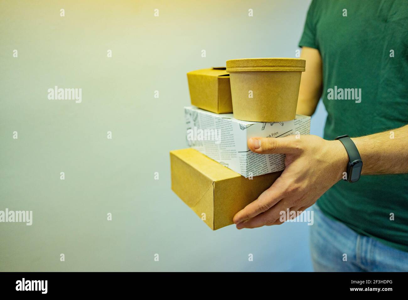 Man holding packed food in arms Stock Photo - Alamy