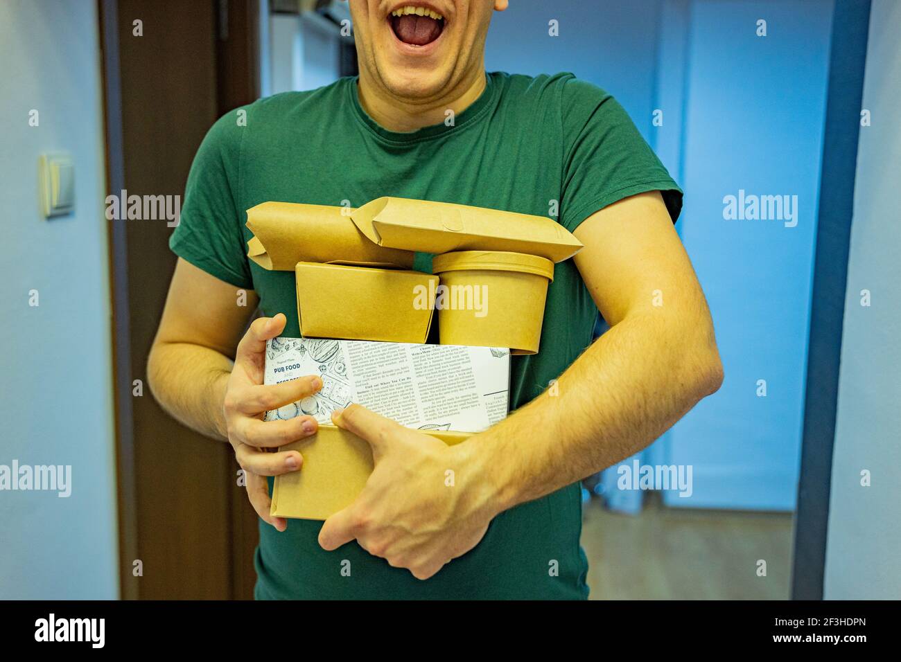 Man holding packed food in arms Stock Photo - Alamy