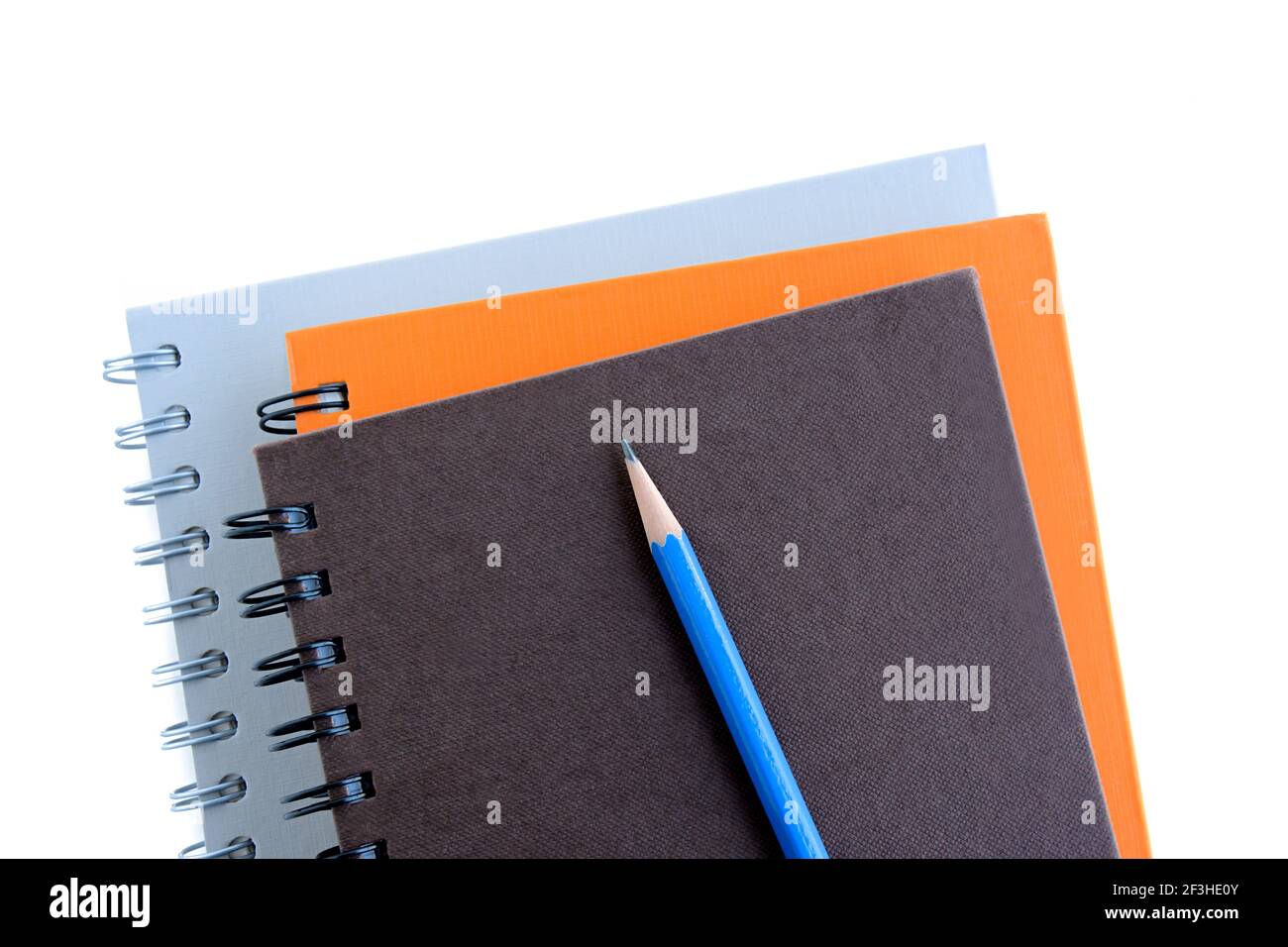 Stack of notebooks (or copybooks) with a pencil - isolated on white ...