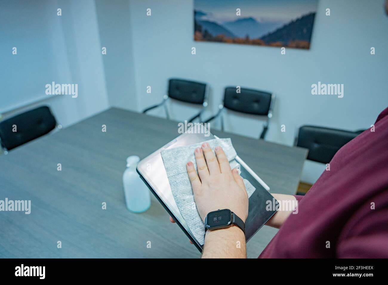 Man cleaning laptop and tablet with white wipe Stock Photo - Alamy
