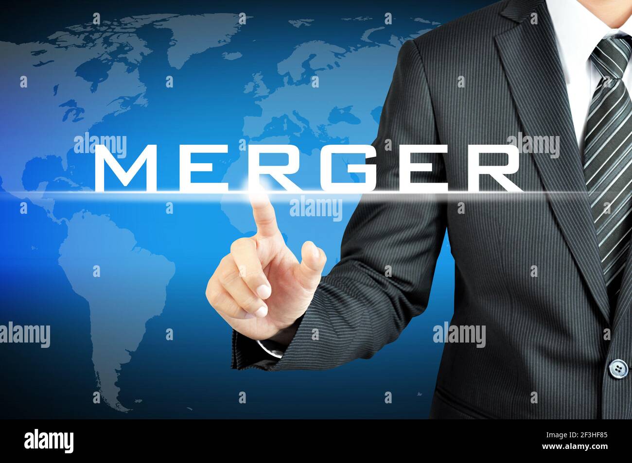 Businessman hand pointing to MERGER sign on virtual screen Stock Photo ...