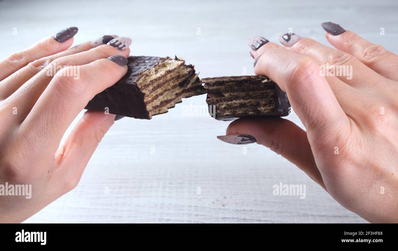 Hand breaking chocolate bar hi-res stock photography and images - Alamy