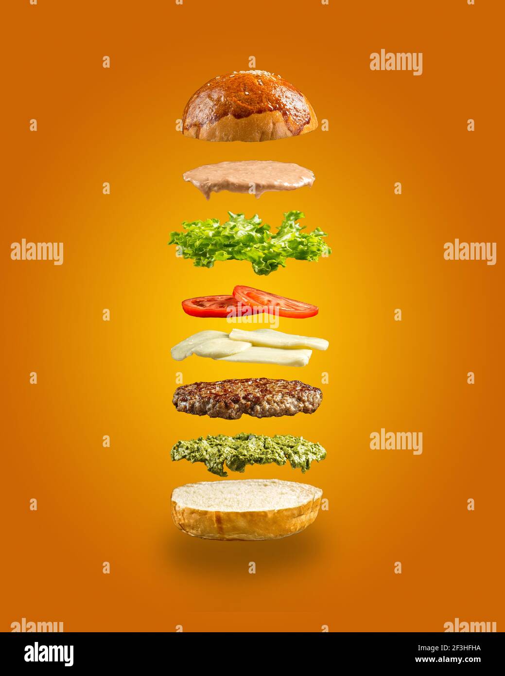 Floating burger ingredients on the yellow background Stock Photo - Alamy