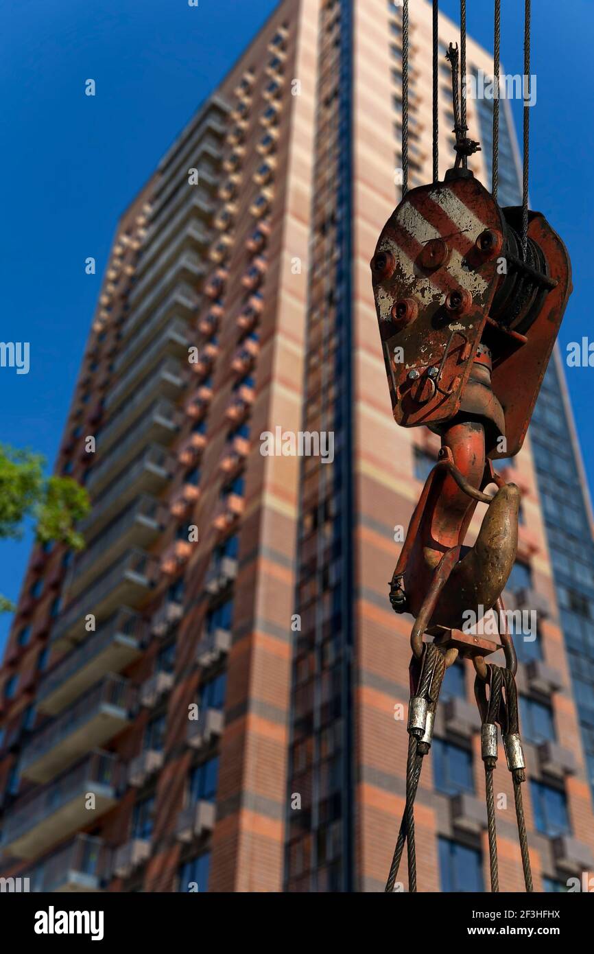 Construction crane hook with multi-storey building under construction ...