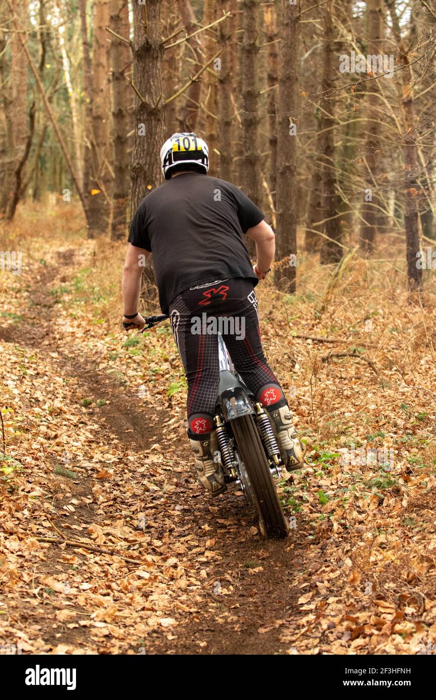Motorcycle trials rider standing up between sections Stock Photo - Alamy