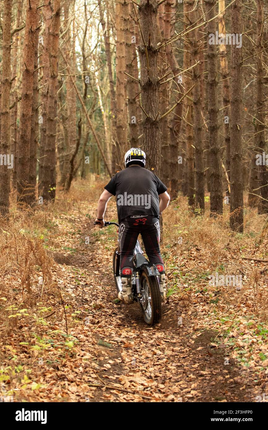Motorcycle trials rider standing up between sections Stock Photo - Alamy