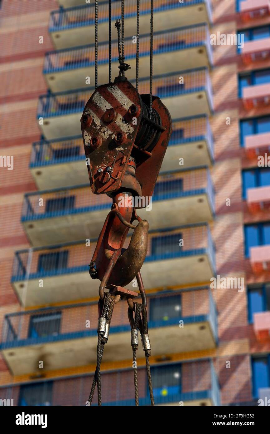 Construction crane hook with multi-storey building under construction ...
