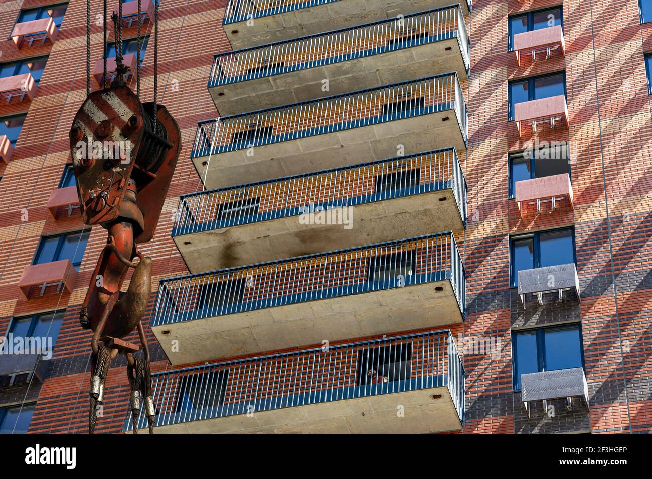Construction crane hook with multi-storey building under construction ...