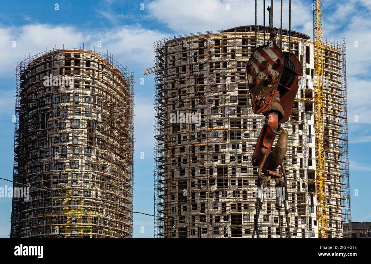 Construction crane hook with multi-storey building under construction ...
