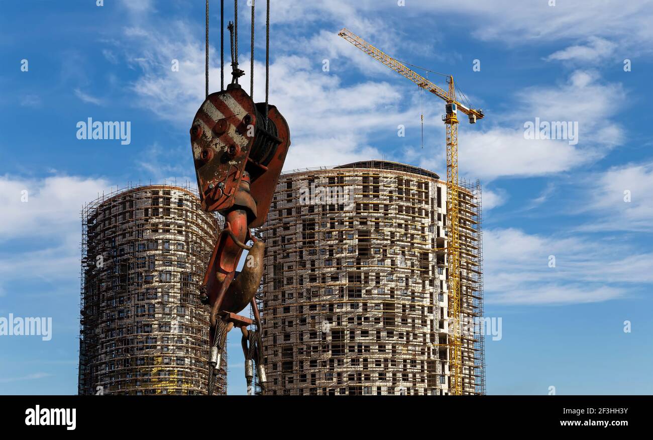 Construction crane hook with multi-storey building under construction ...
