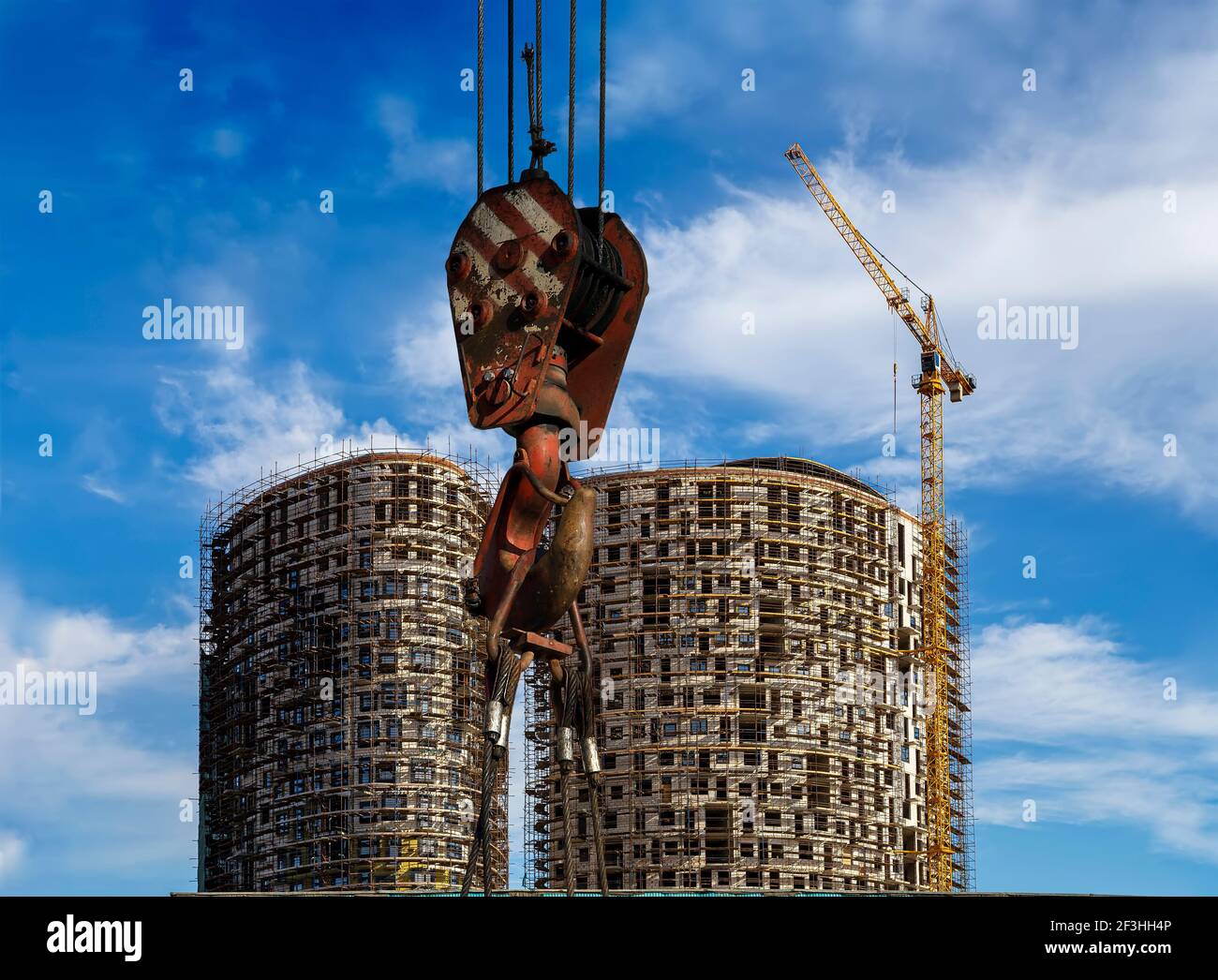 Construction crane hook with multi-storey building under construction ...