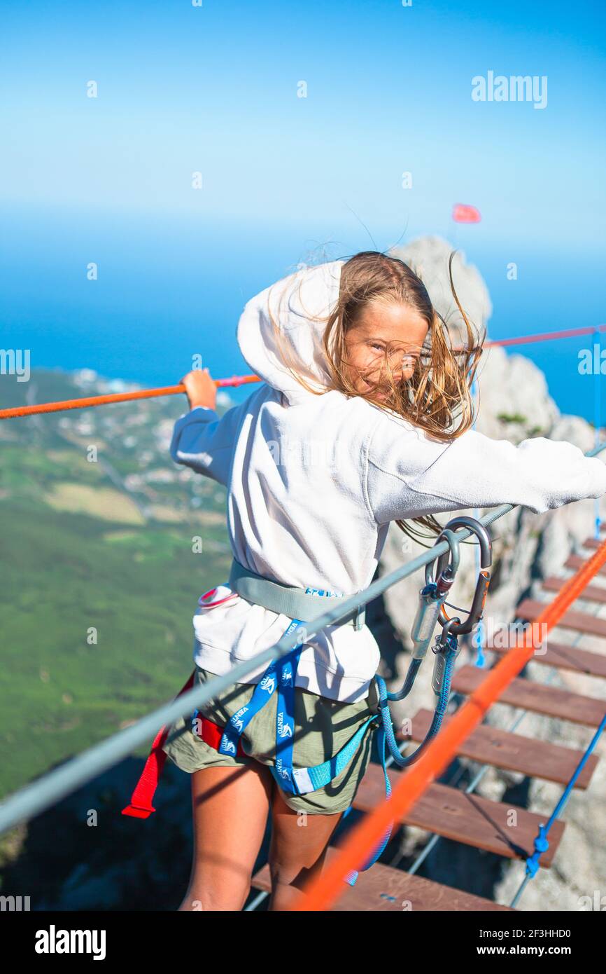 Girls crossing the chasm on the rope bridge Stock Photo - Alamy