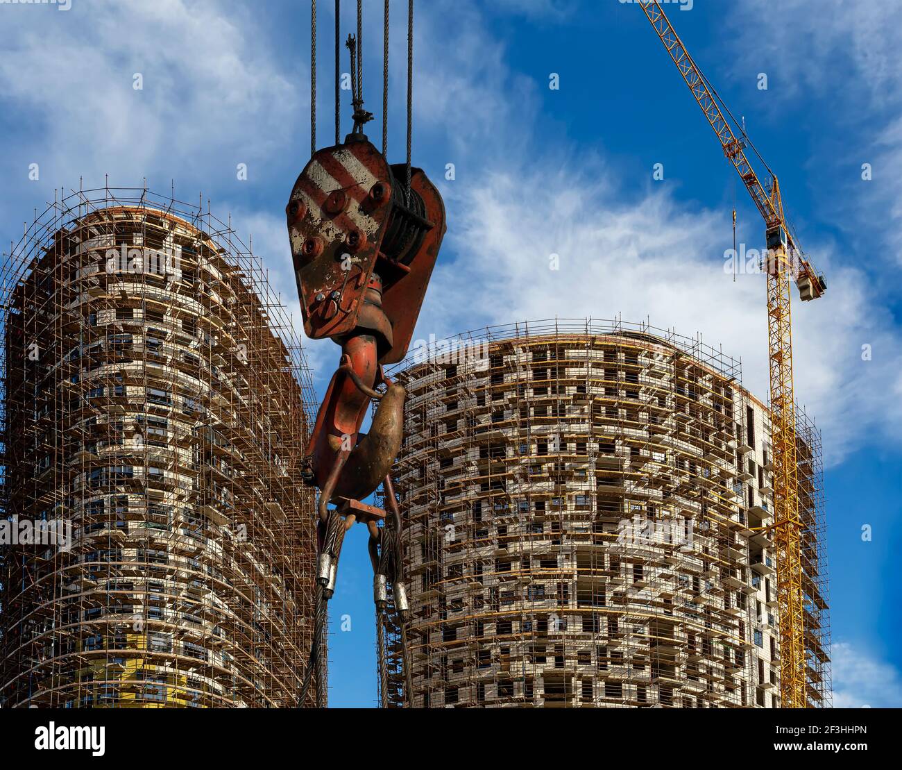 Construction crane hook with multi-storey building under construction ...