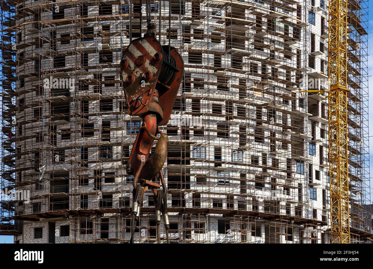 Construction crane hook with multi-storey building under construction ...