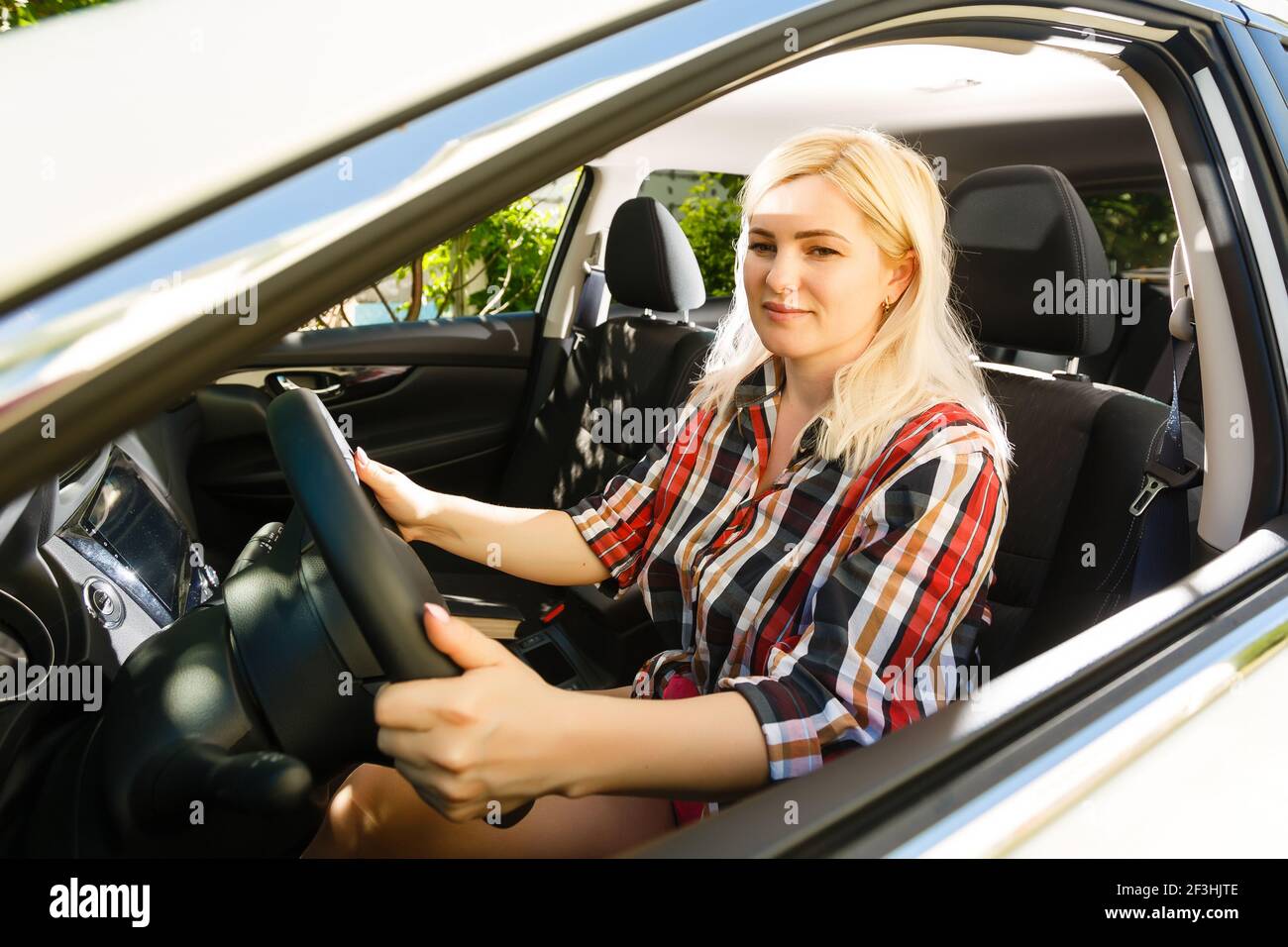 Young woman driving her car Stock Photo - Alamy