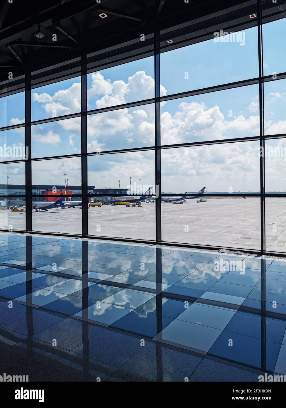 Terminal of airport. View looking out to airport with aircraft, blue ...