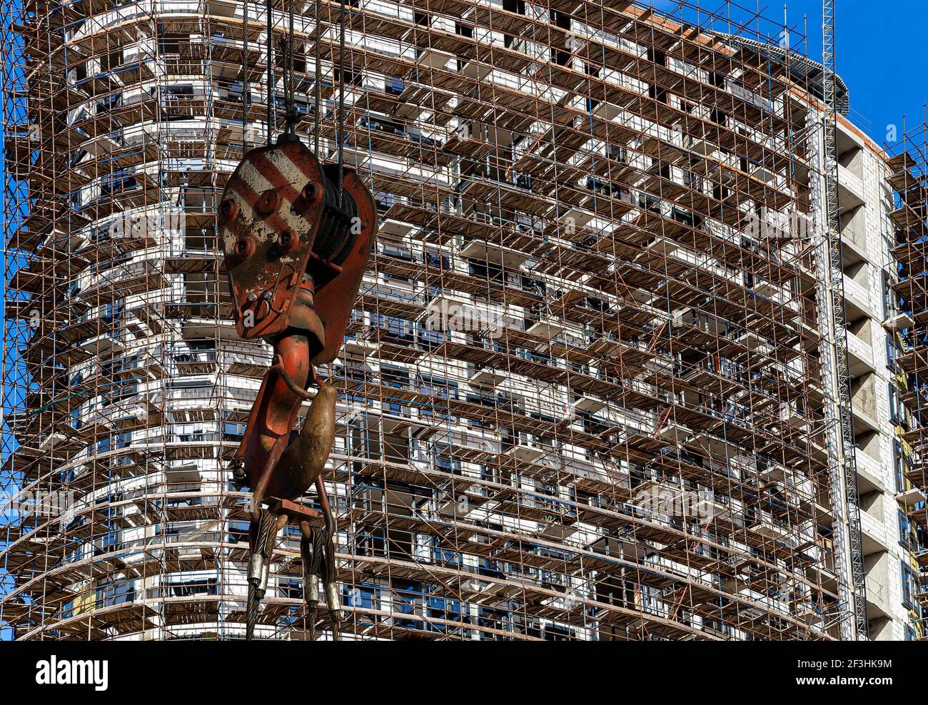 Construction crane hook with multi-storey building under construction ...