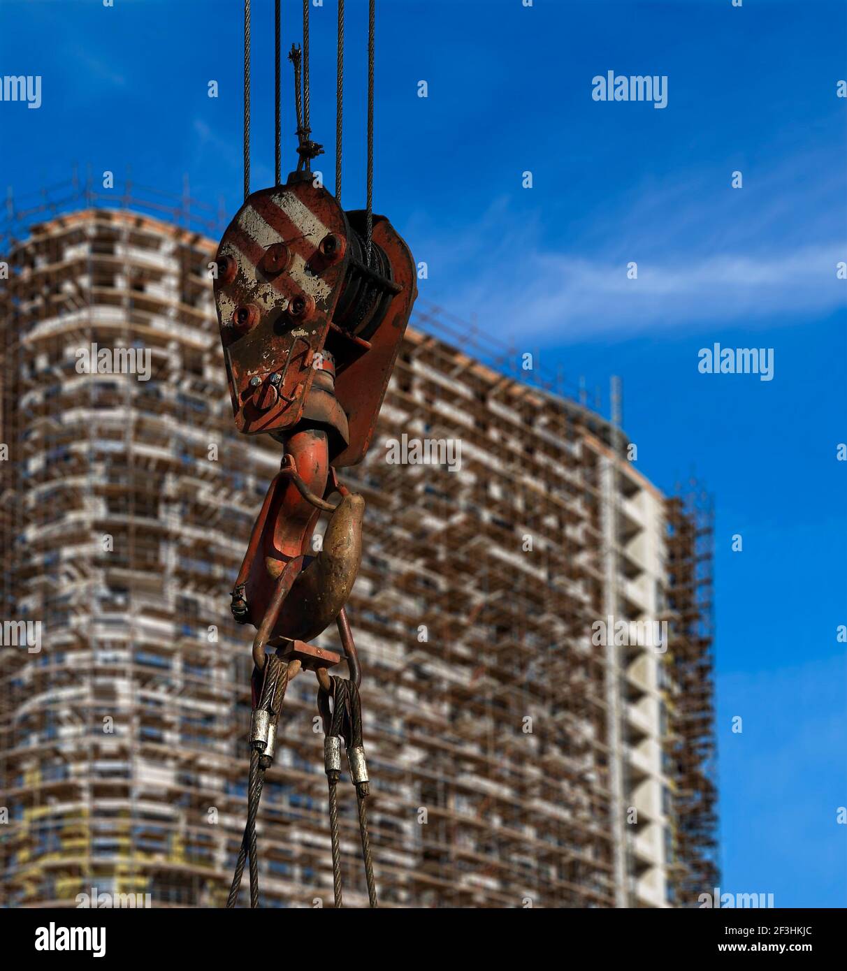 Construction crane hook with multi-storey building under construction ...