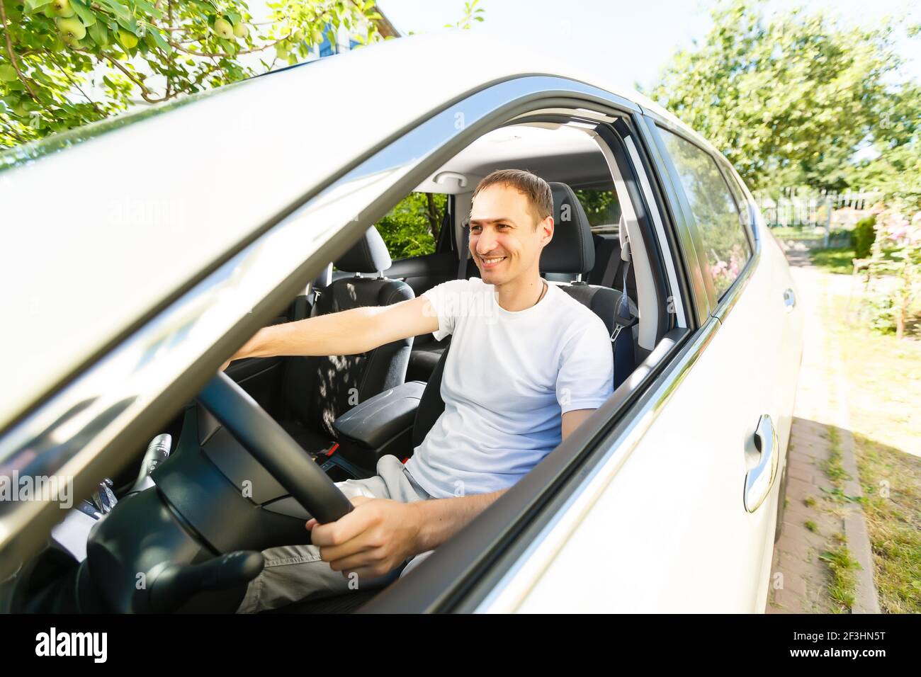 Portrait of an handsome guy driving his car Stock Photo - Alamy