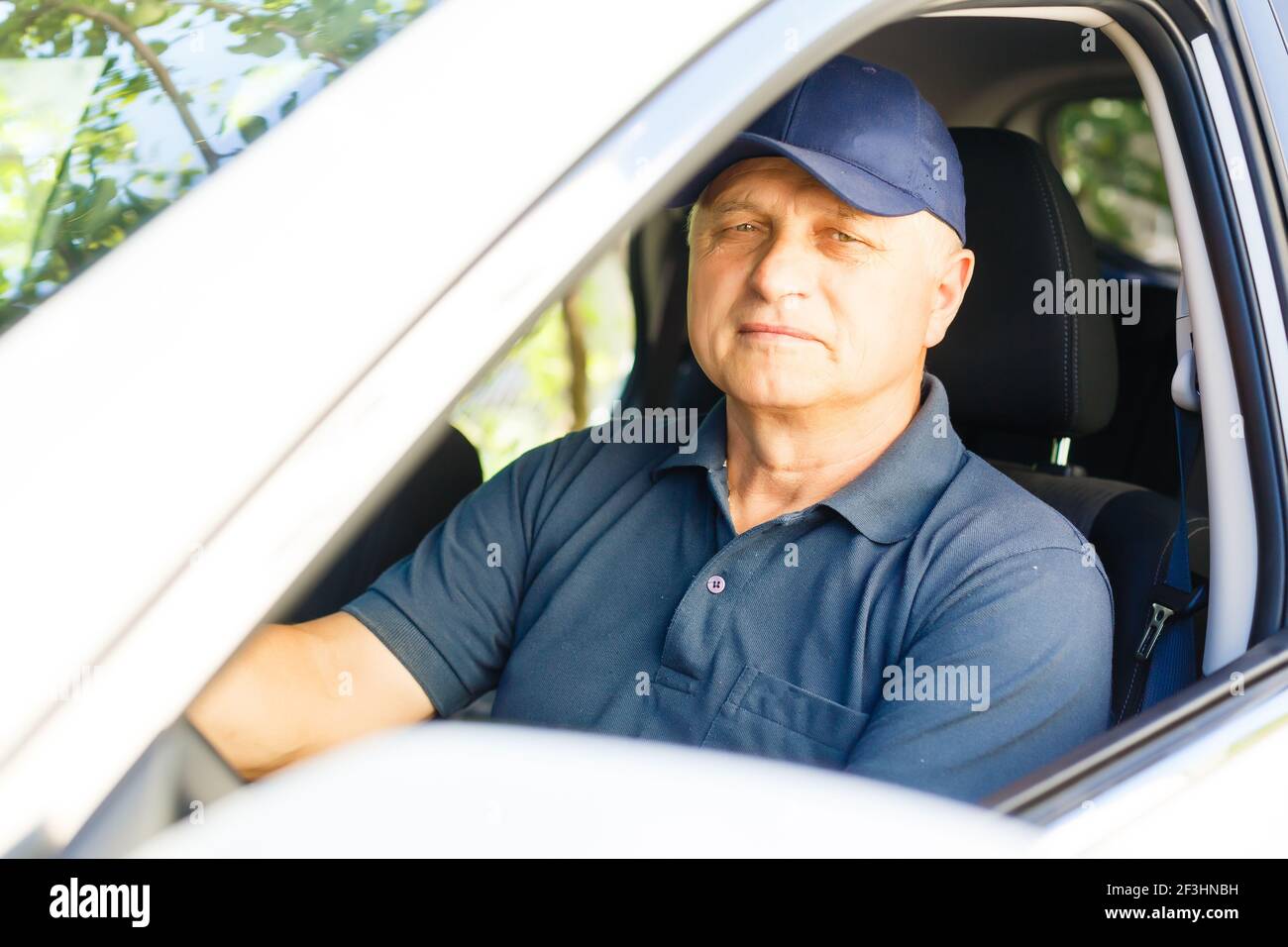 Elderly man driving a car Stock Photo - Alamy