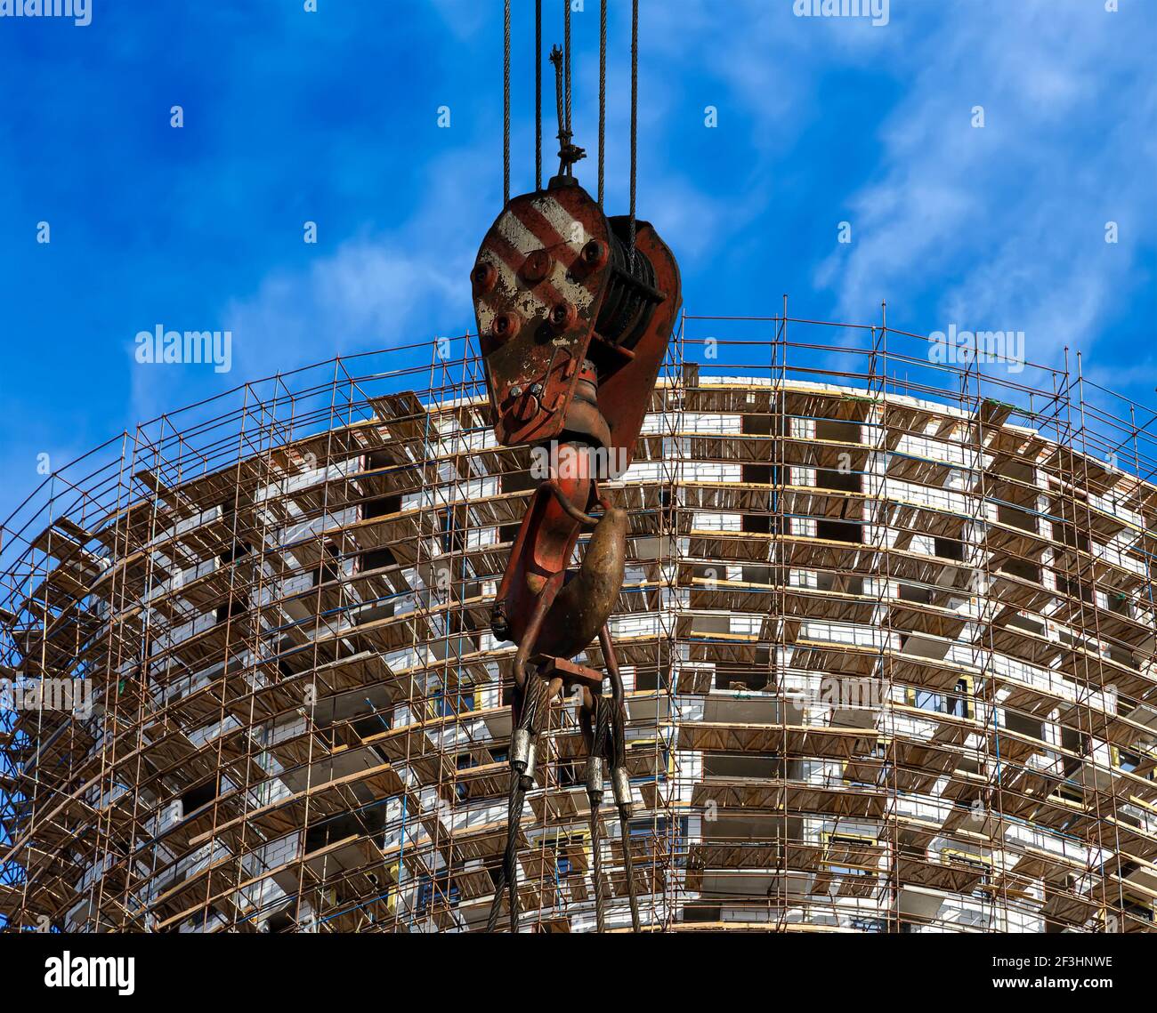 Construction crane hook with multi-storey building under construction ...