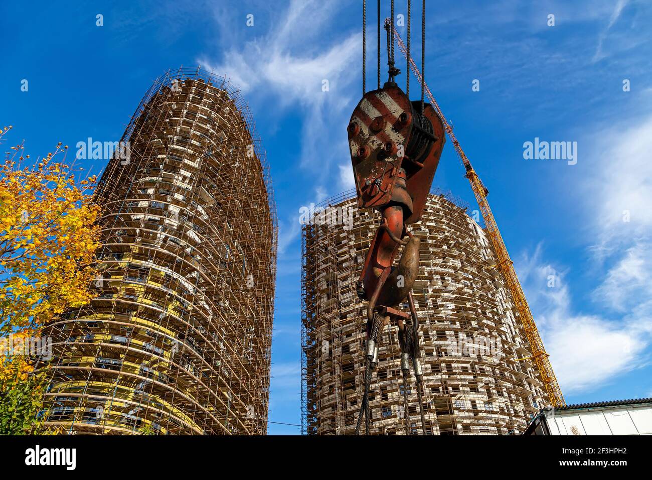 Construction crane hook with multi-storey building under construction ...