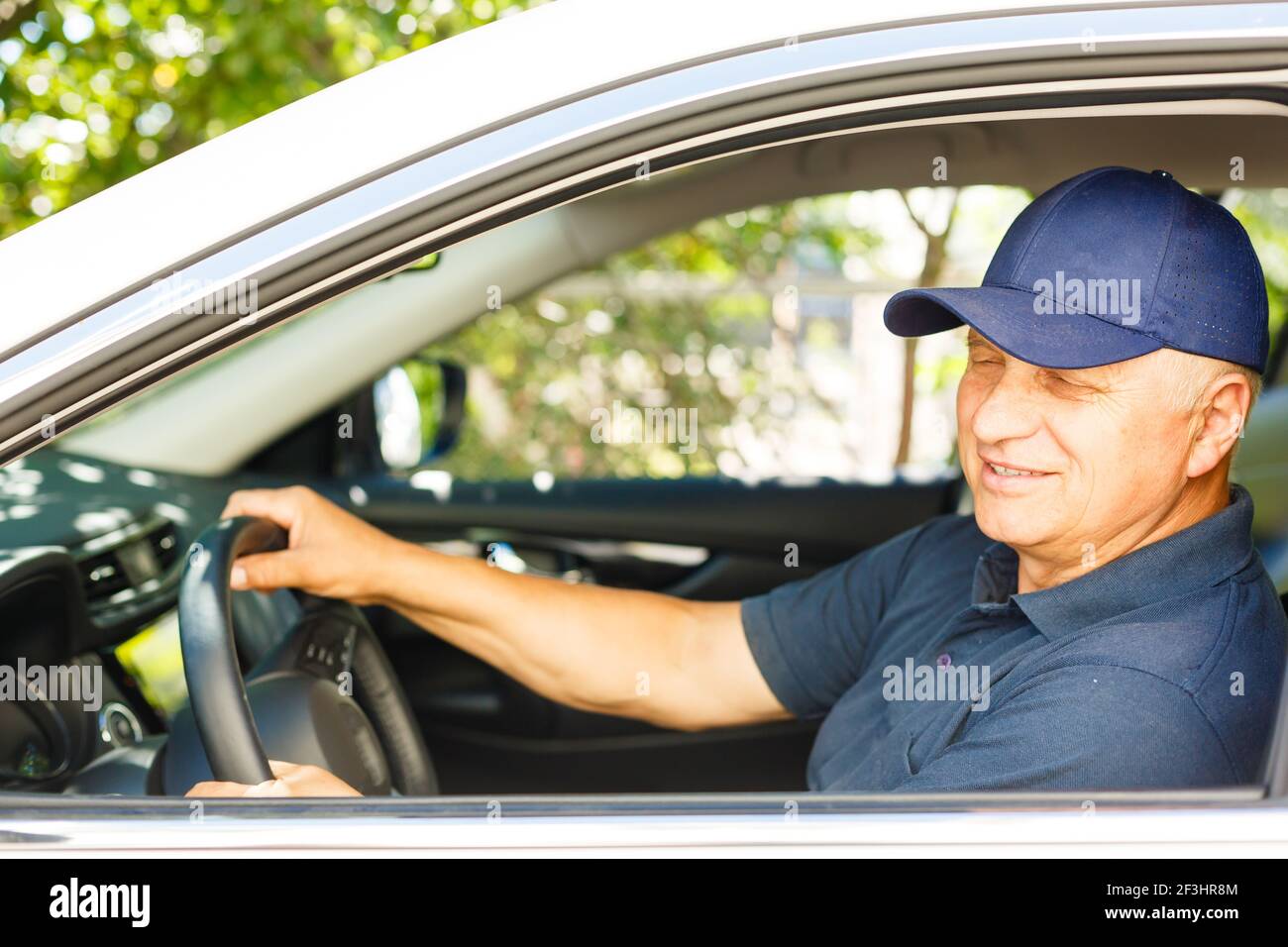 Elderly man driving a car Stock Photo - Alamy
