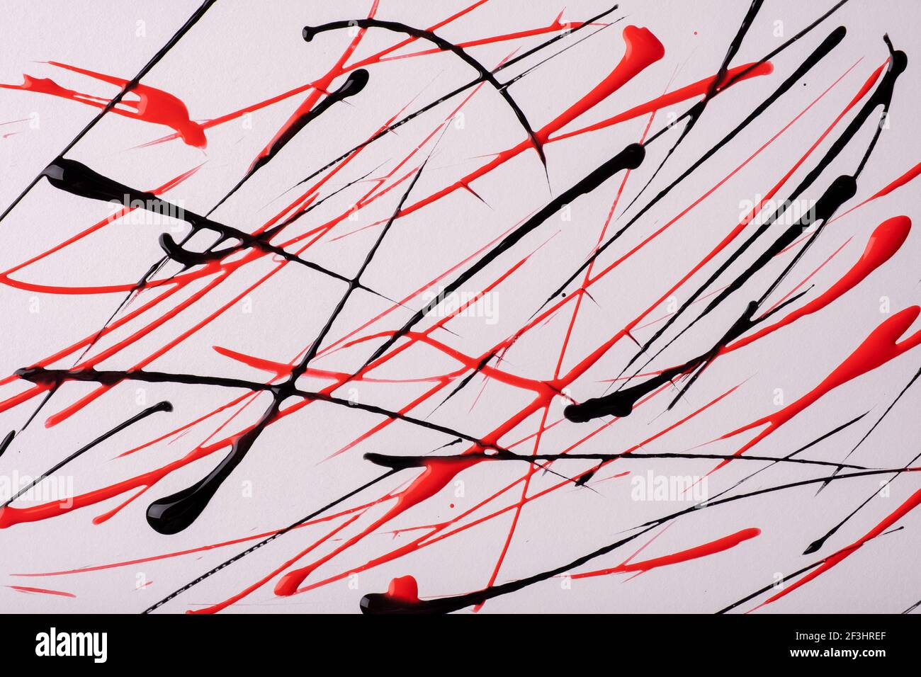 Thin Red And Black Lines And Splashes Drawn On White Background