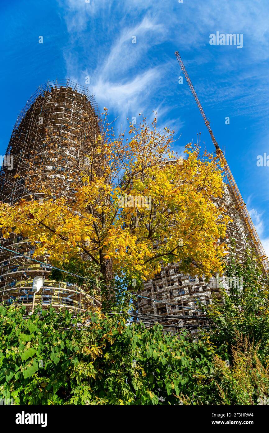 Multi-storey building under construction with scaffolding (new ...