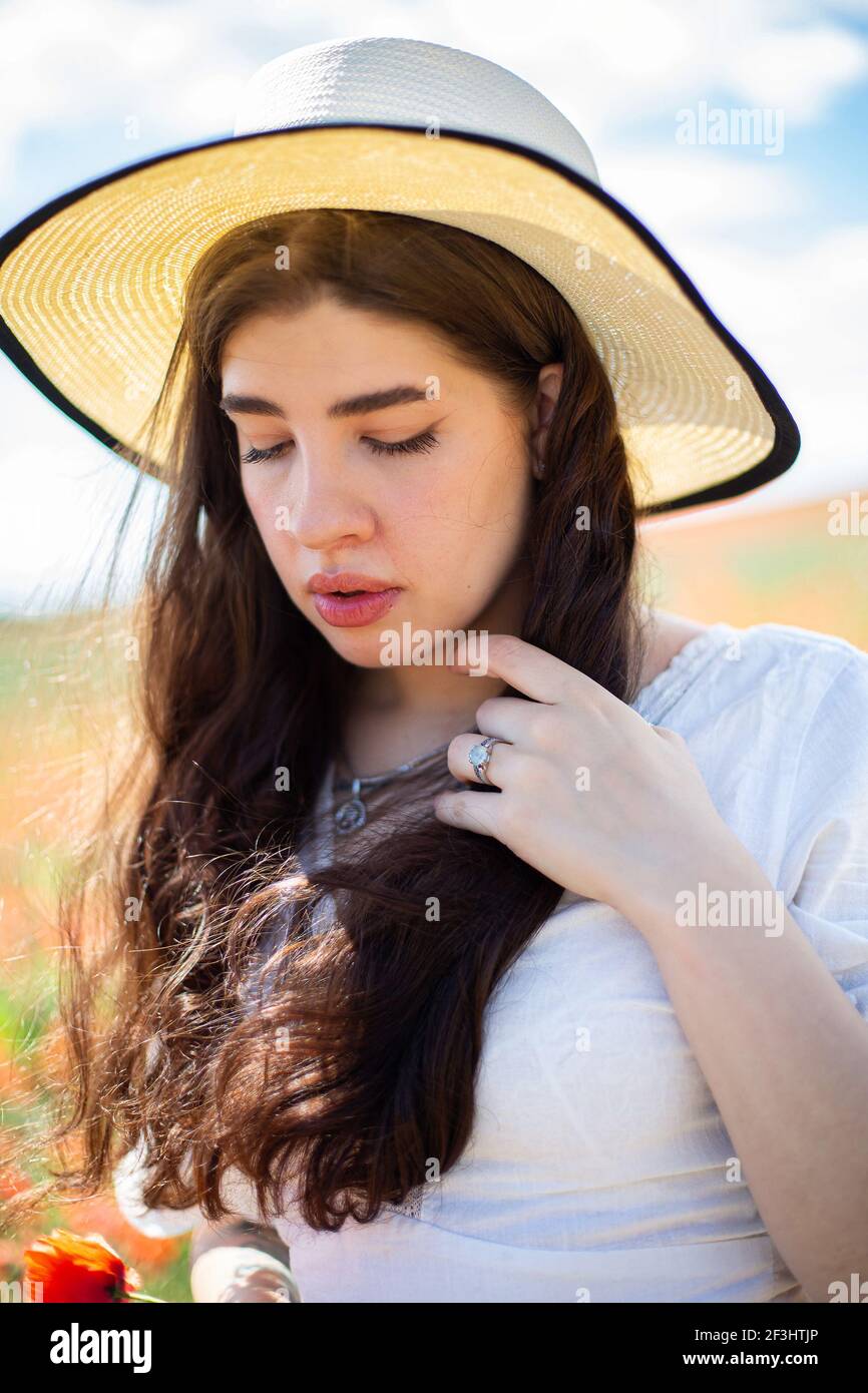 Beautiful woman sitting in poppy hi-res stock photography and images ...