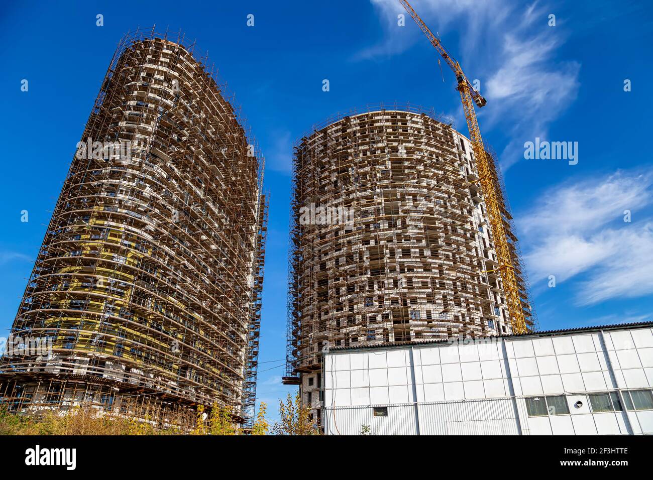 Multi-storey building under construction with scaffolding (new ...