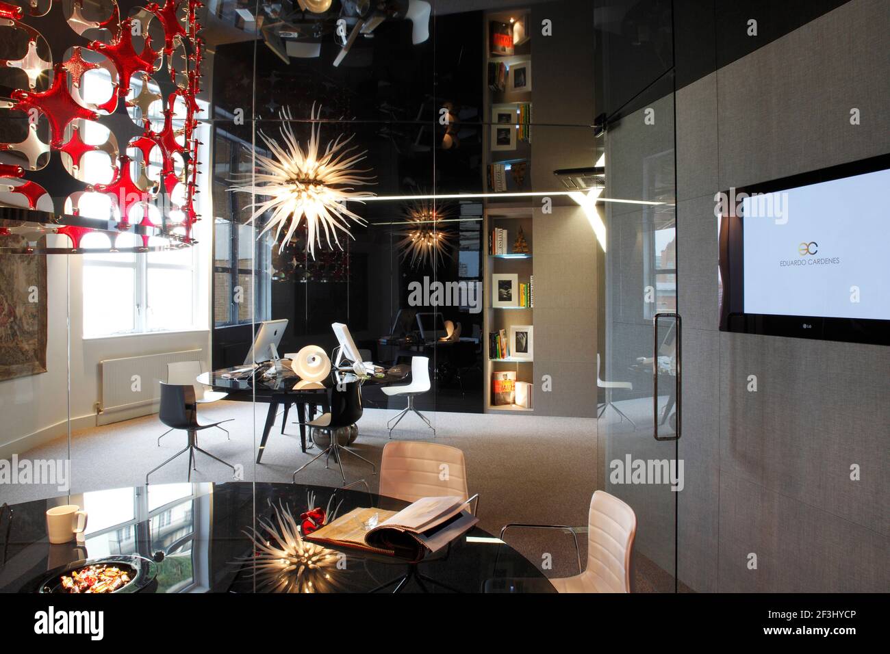 Wide view across office with plasma screen set into hessian wall panels ...