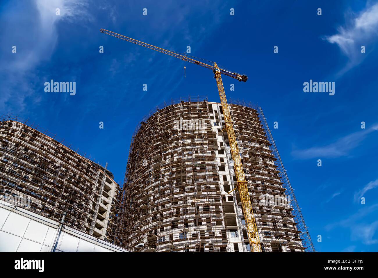 Multi-storey building under construction with scaffolding (new ...