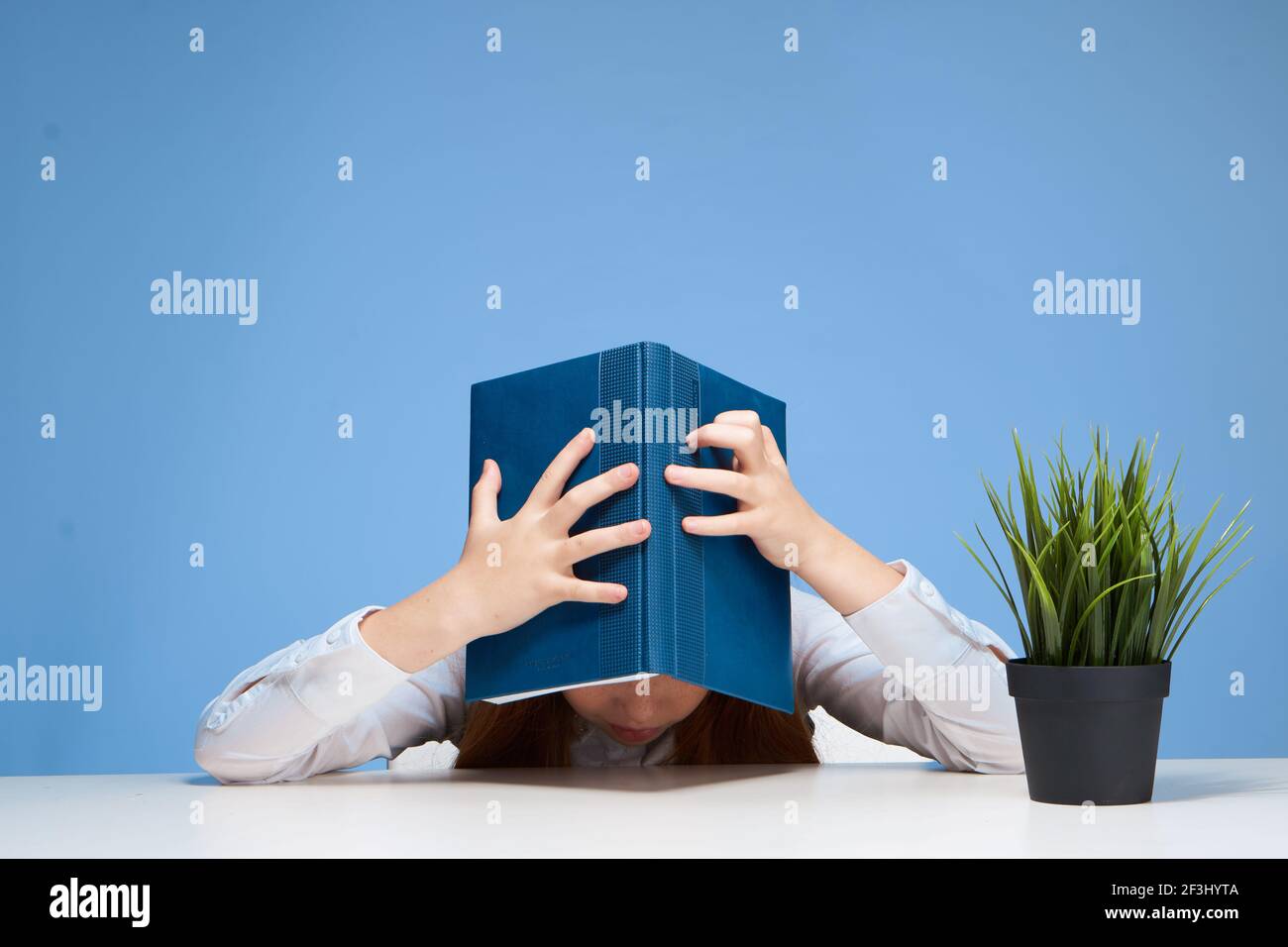 schoolgirl with a book on her head learning lessons lifestyle Stock ...