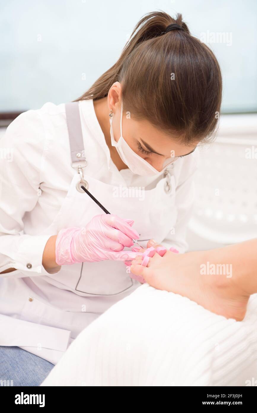 Foot treatment in SPA salon. Nail artist in beauty salon making ...