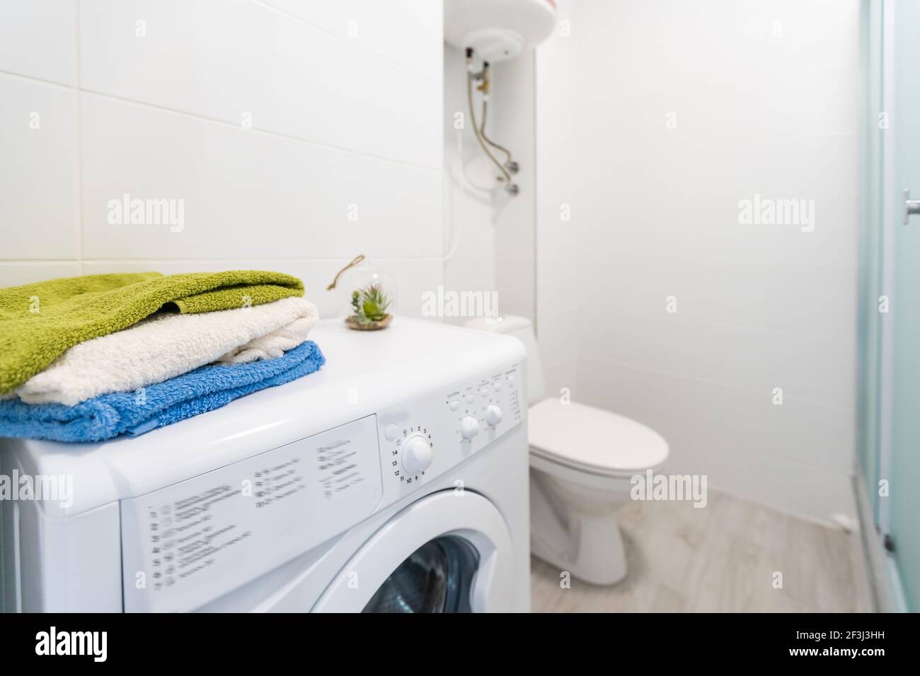 Washing machine in the bathroom, laundry Stock Photo - Alamy