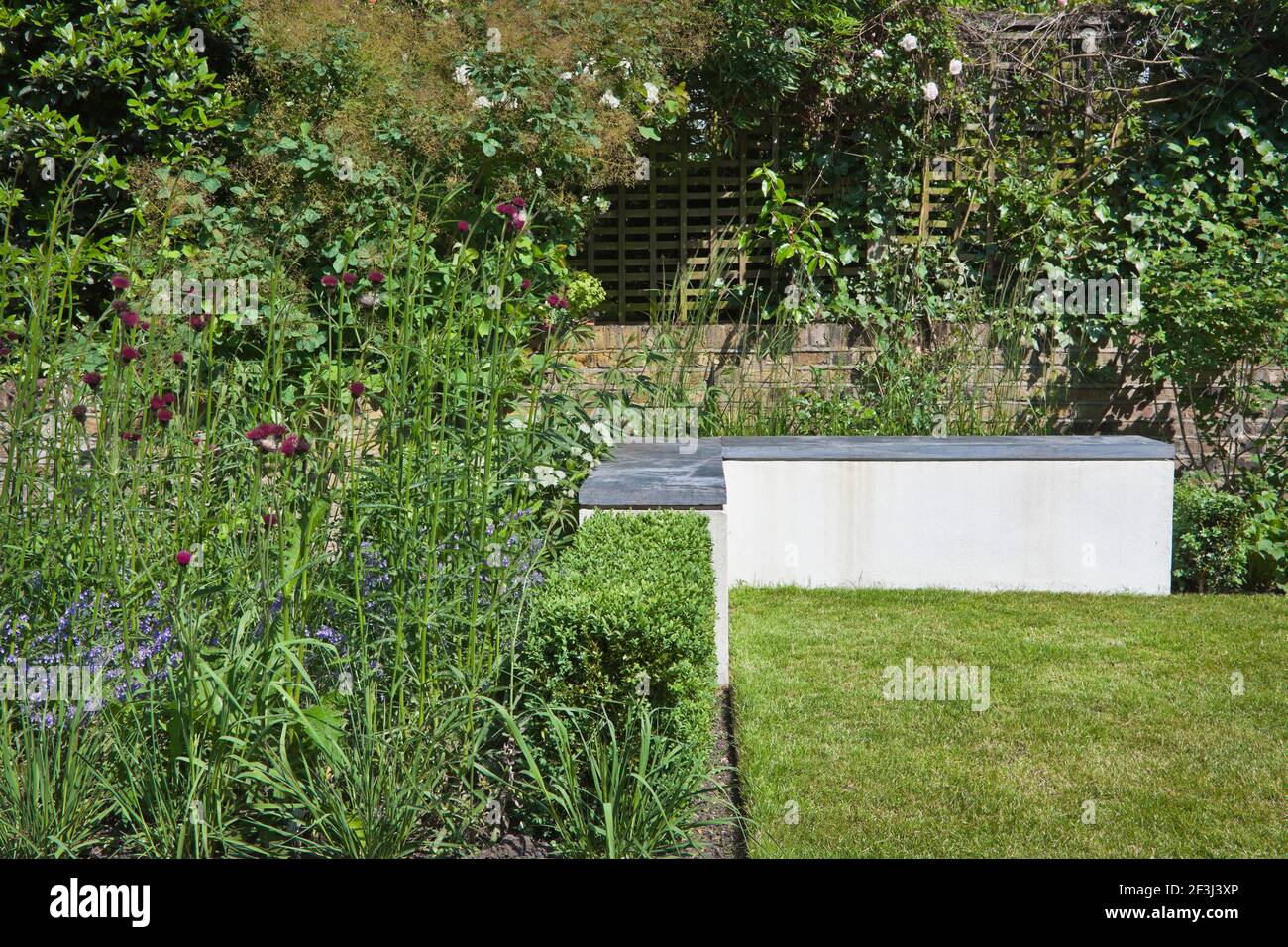 L-shaped concrete bench with slate top in Irenie and Adam Cossey's rear ...