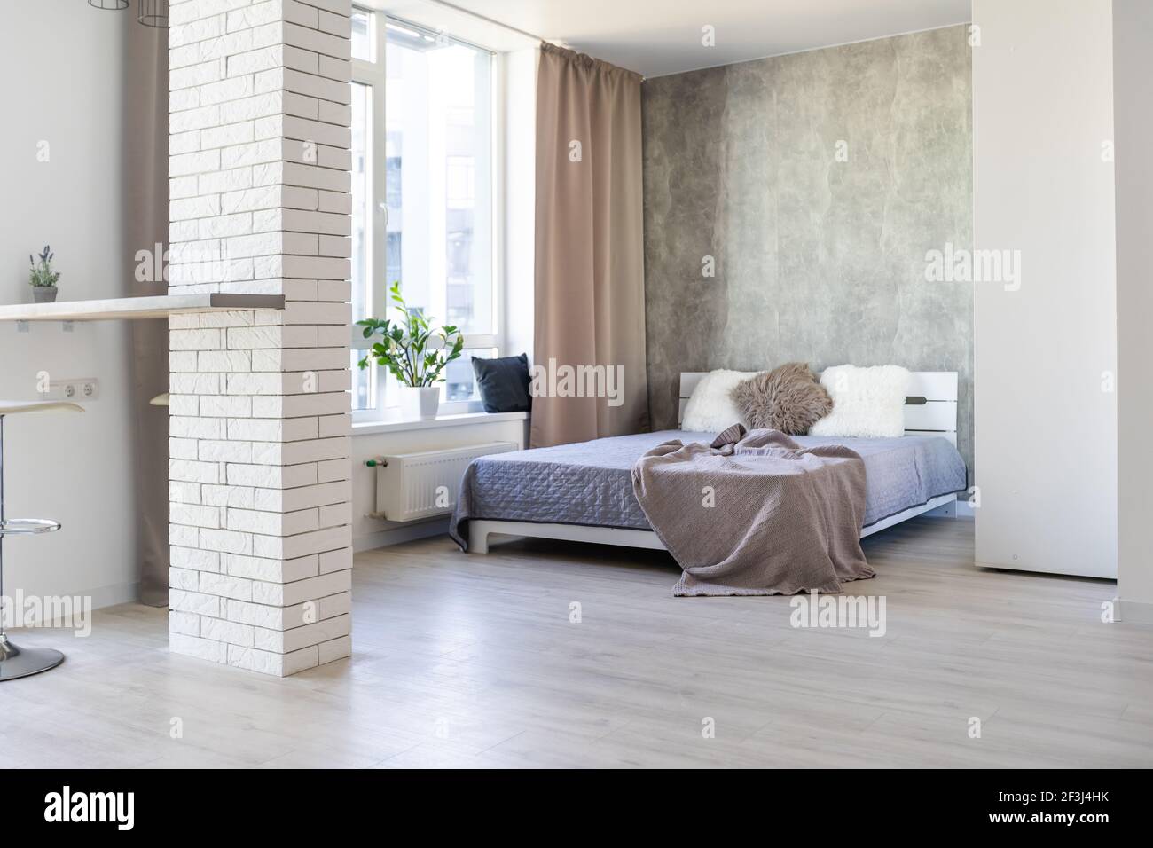 Interior of white and gray cozy bedroom Stock Photo - Alamy