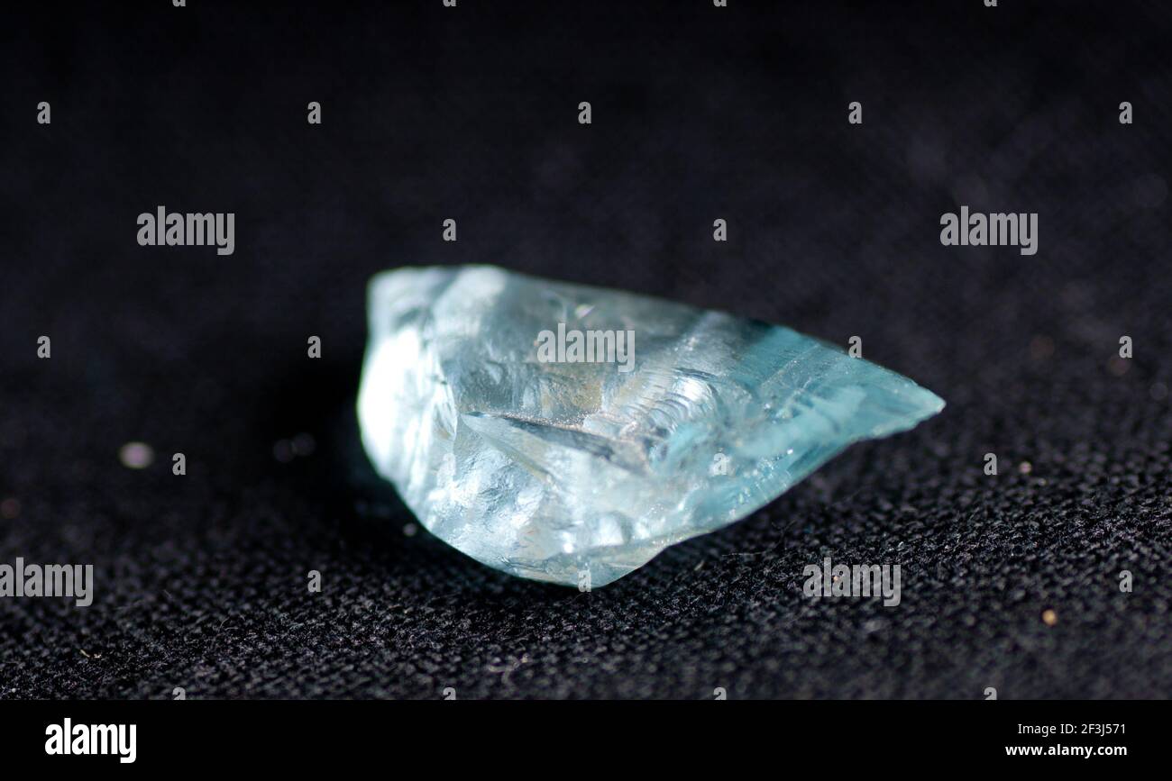 vibrant blue clrea beryl crystal mineral sample on black background ...