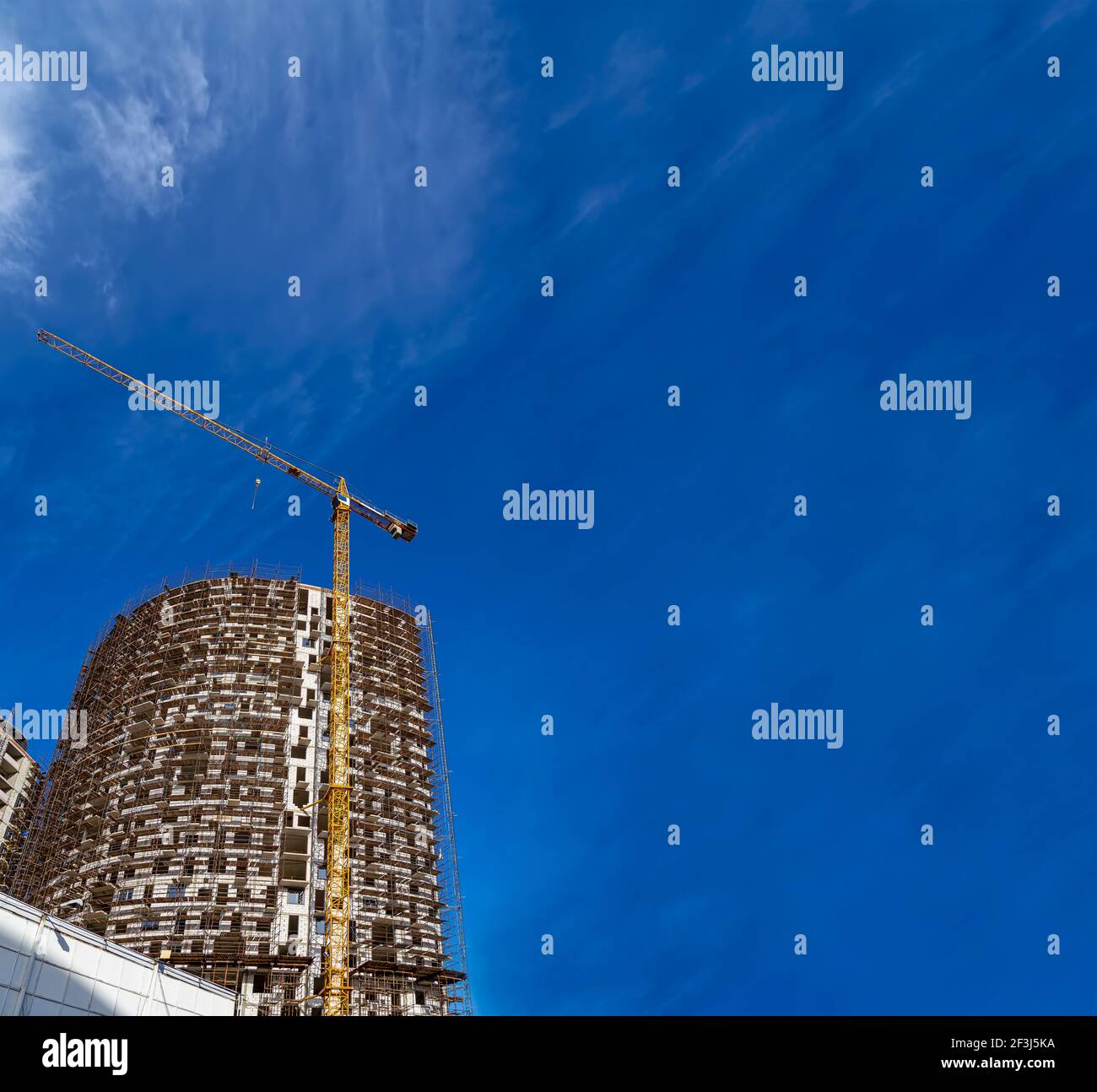 Multi-storey building under construction with scaffolding (new ...