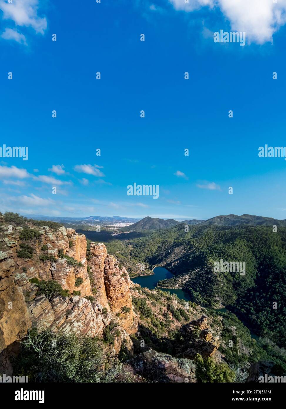 Rocks with layers, mountain range and dam Stock Photo - Alamy
