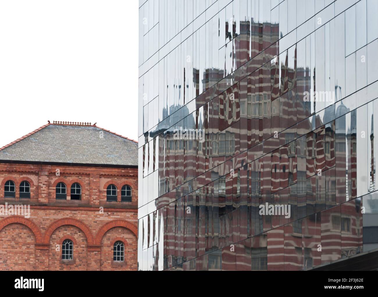 Ornate building reflected in the black glass facade of the Mann Island ...
