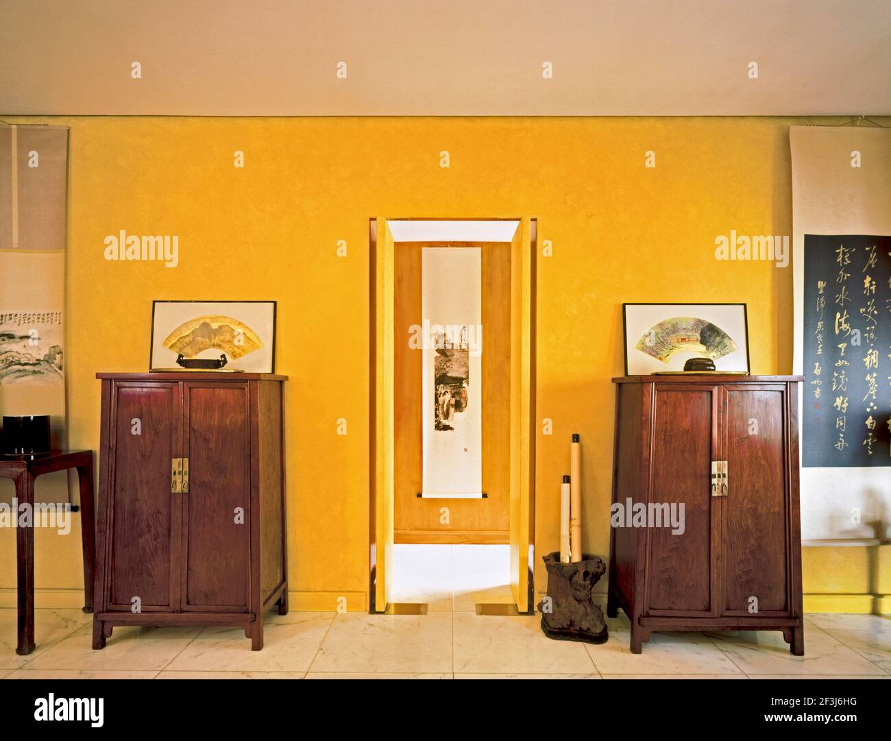 Doorway flanked by two chinese Ming cabinets in an elegant home in Hong ...