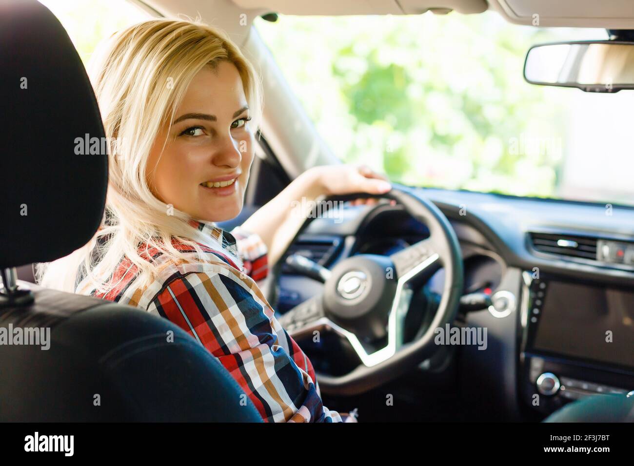 Young woman driving her car Stock Photo - Alamy
