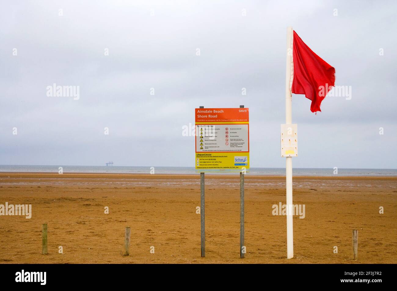 Red warning sign beach england hi-res stock photography and images - Alamy