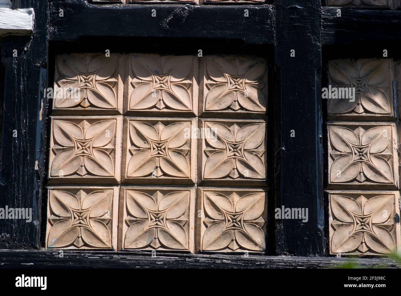 Plaster patterned tiles in a wood timber frame, on a residential ...
