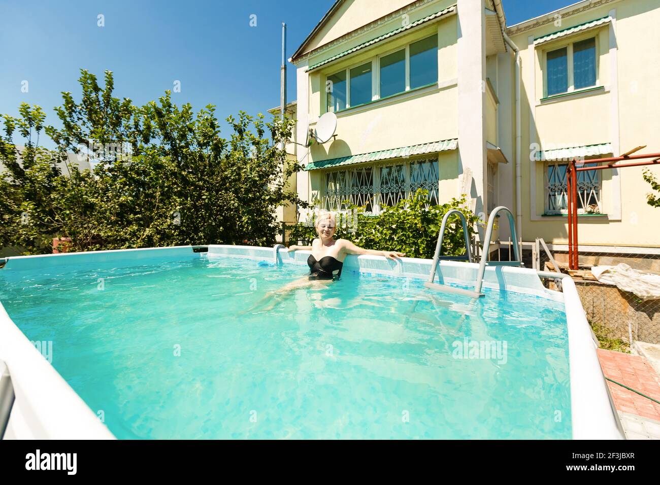 Private swimming pool at summertime Stock Photo - Alamy
