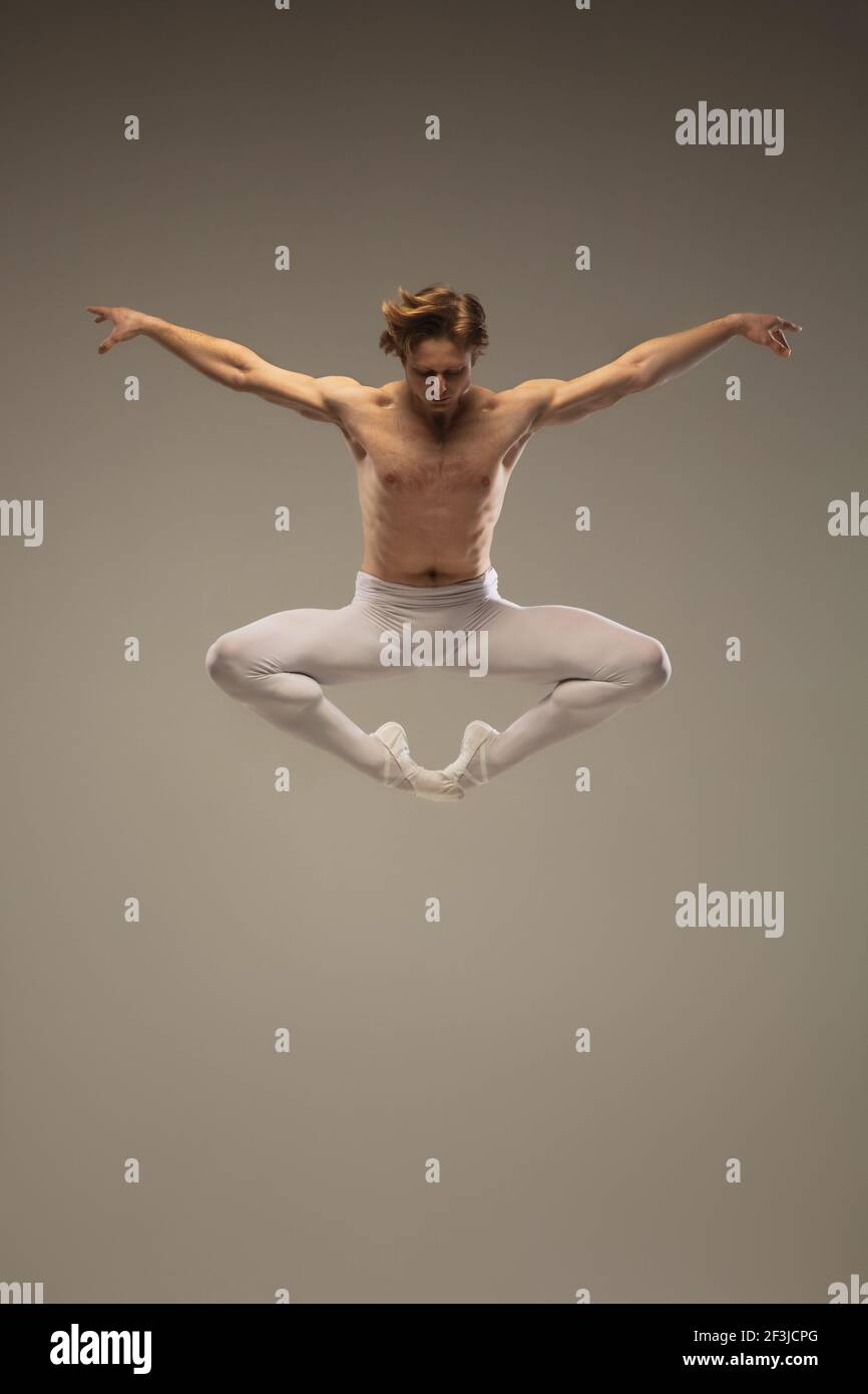 Freedom. Young and graceful ballet dancer isolated on studio background ...